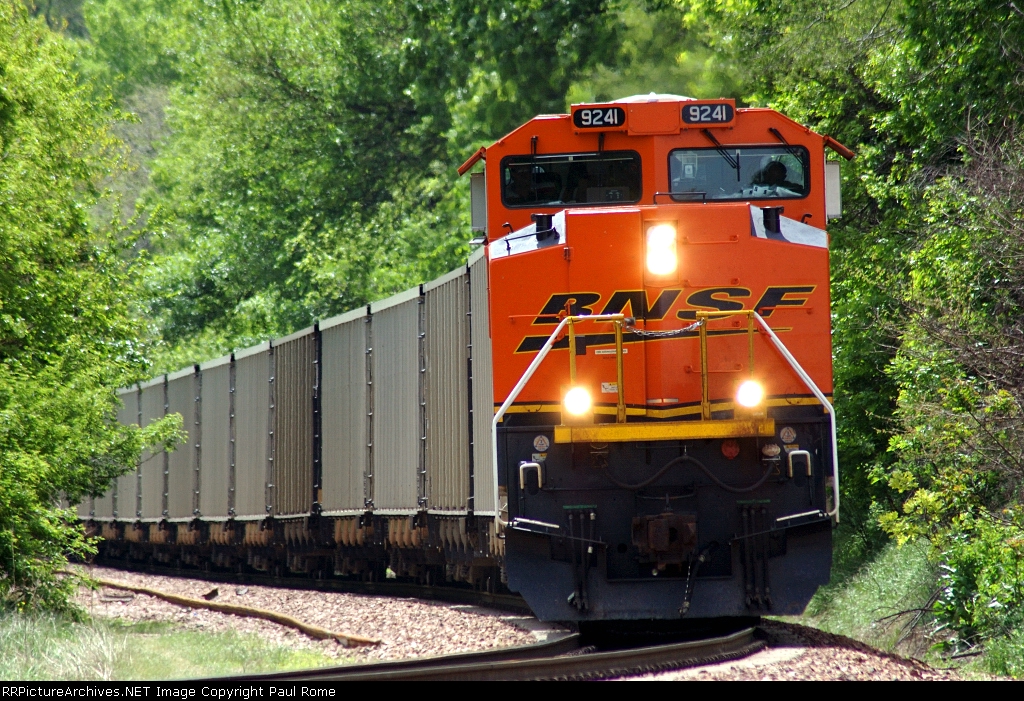 BNSF 9241, EMD SD70ACe, drops down grade with westbound empties